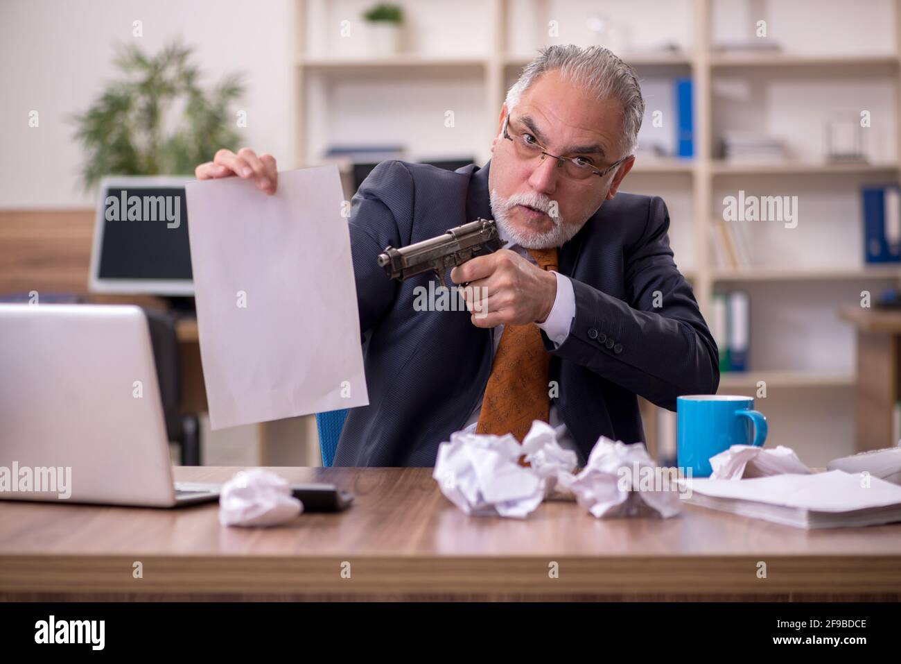 Old employee in paper recycling concept Stock Photo - Alamy