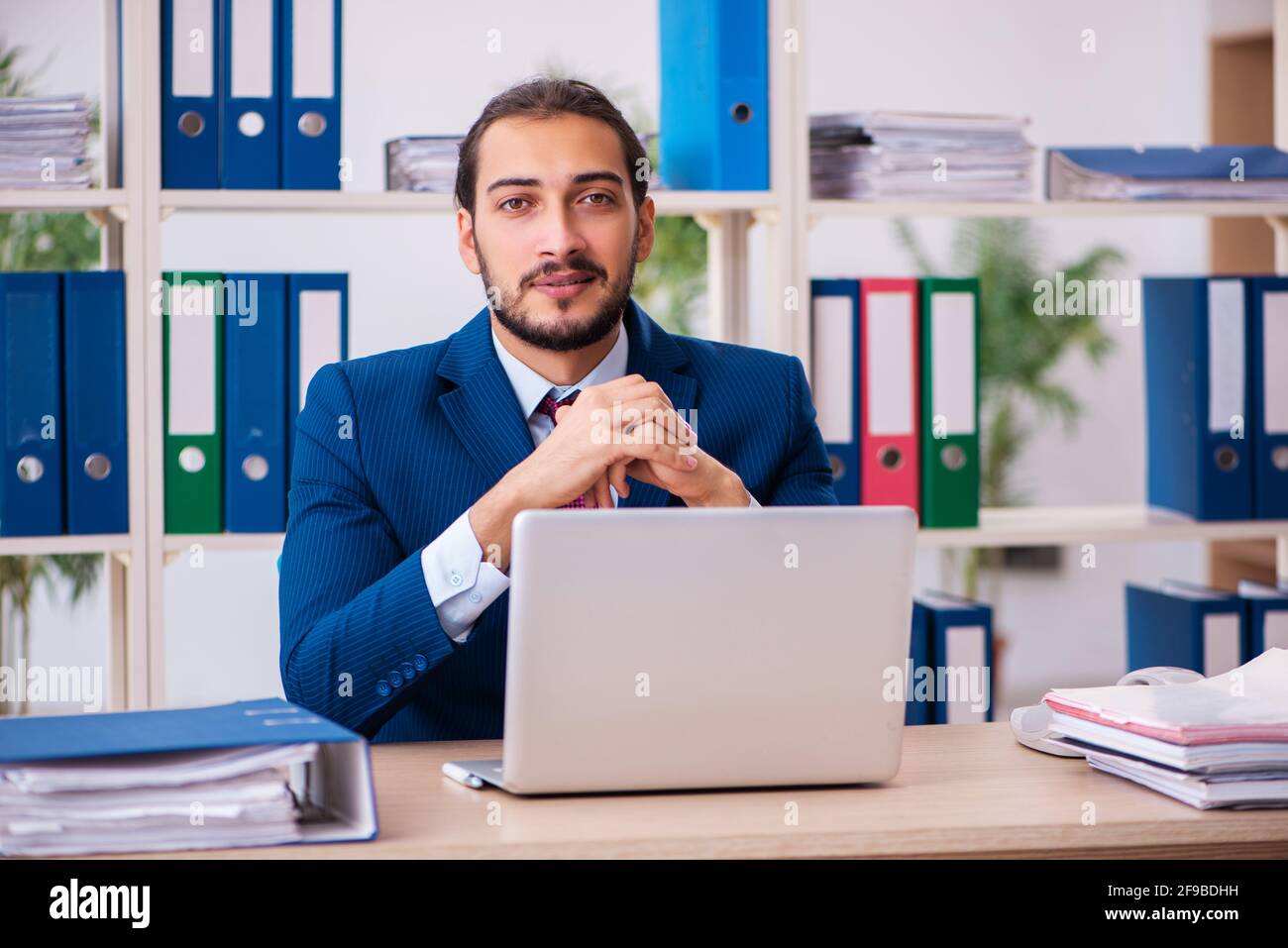 Young employee and too many work in the office Stock Photo - Alamy