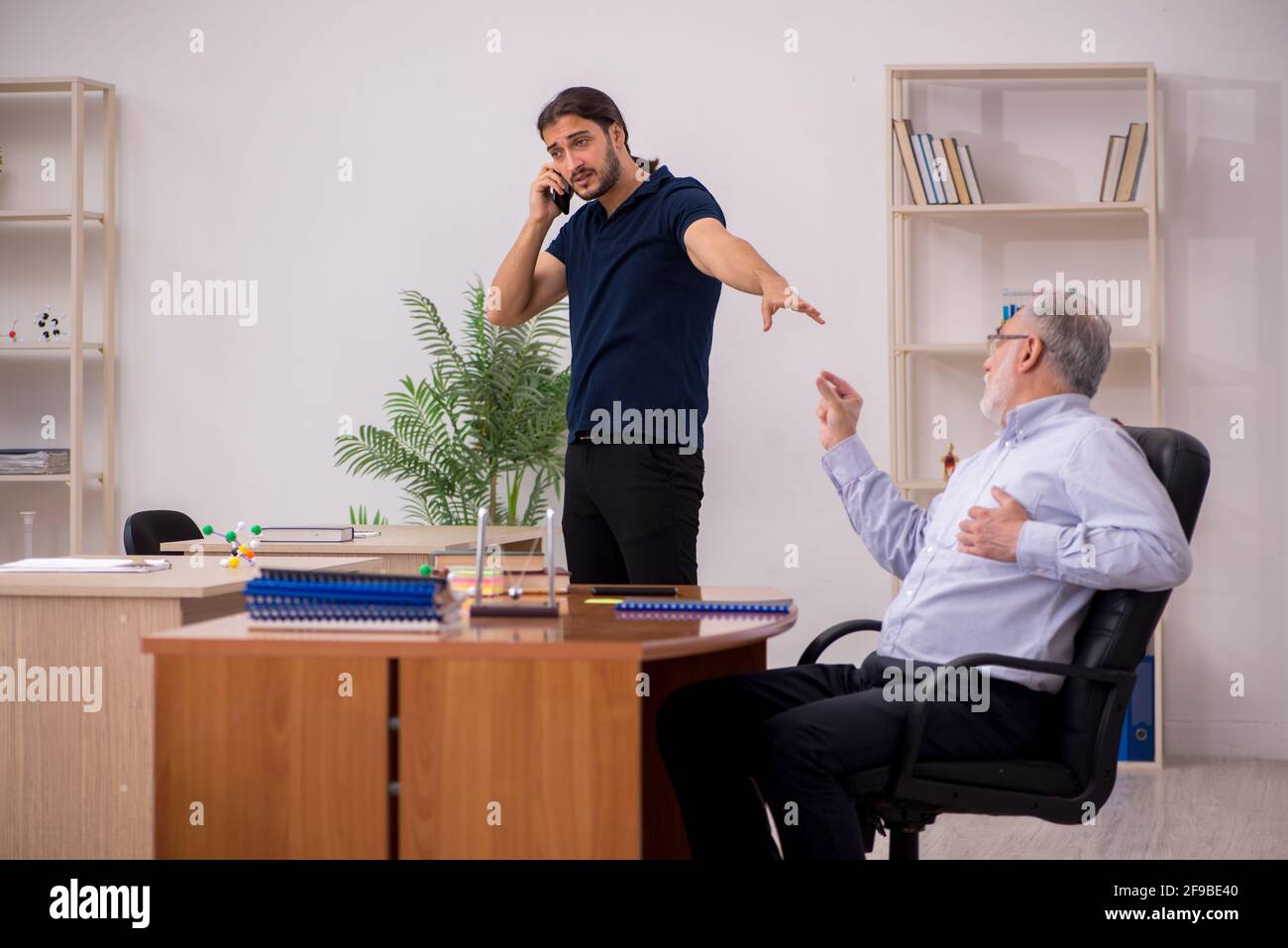 Aged male teacher feeling bad during individual lesson Stock Photo - Alamy