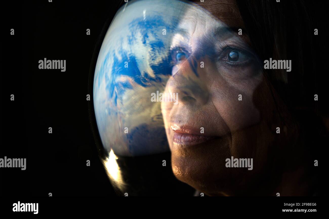 Portrait of the adult female astronaut looking at planet earth - Space ...