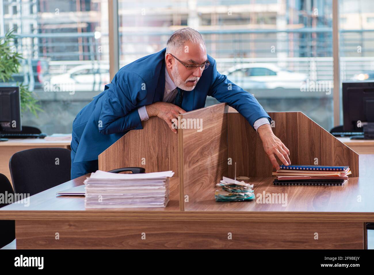 Old employee working in the office Stock Photo - Alamy