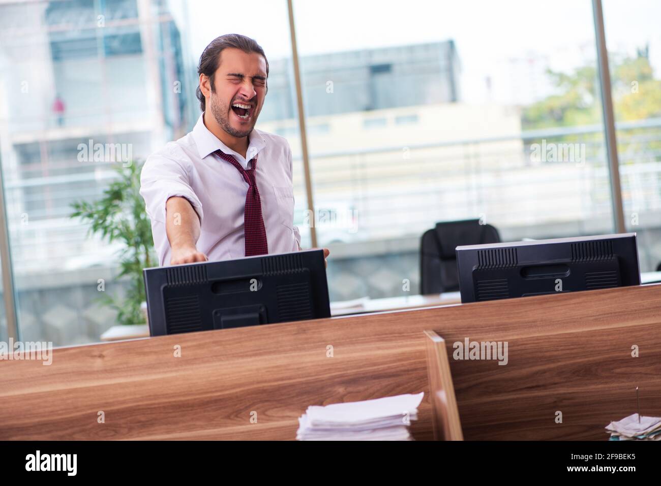 Young employee and too many work in the office Stock Photo - Alamy