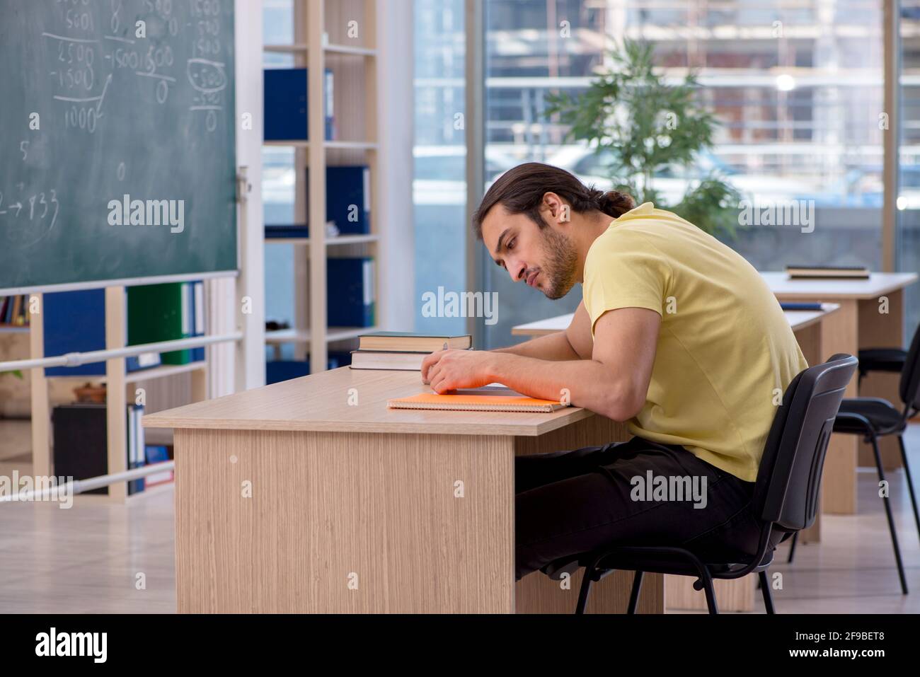 Male student sitting in the classroom Stock Photo - Alamy