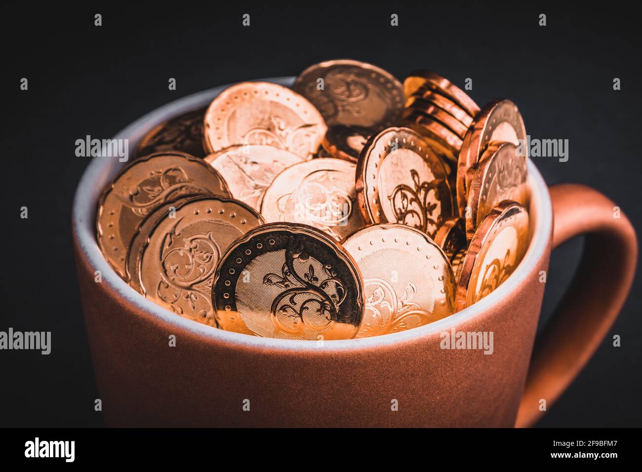 Golden Coins in cups on black background. Tax, Finance, Profit and ...