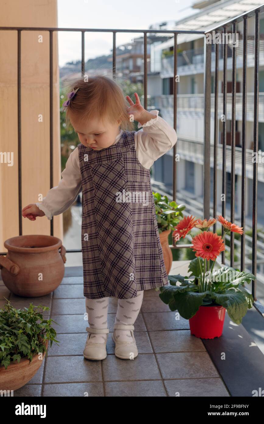 Girl standing by a railing of the balcony Stock Photo - Alamy