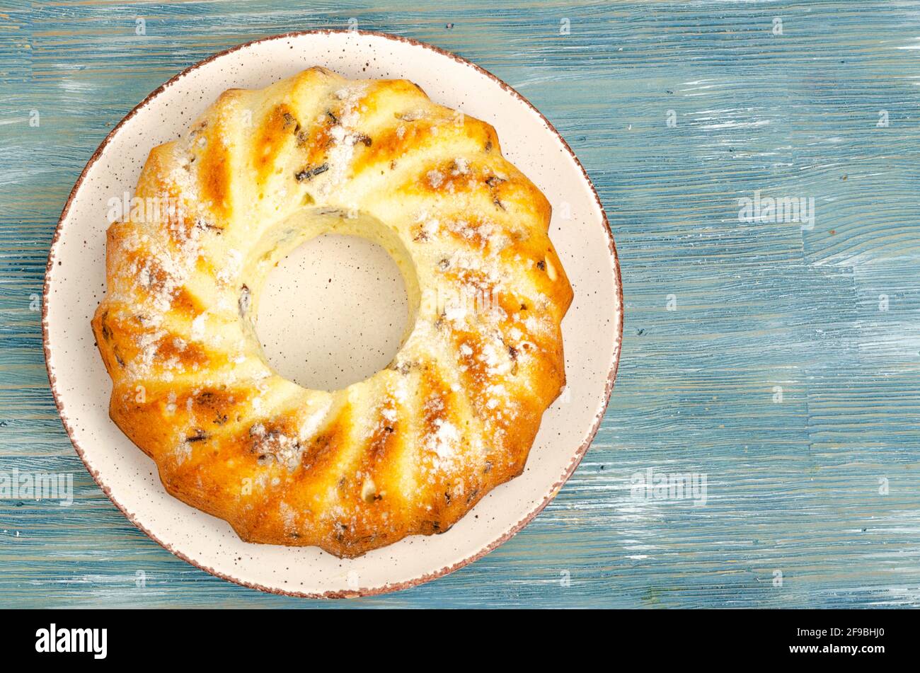 Round delicious biscuit cake with fruit, raisins and dried cranberries ...