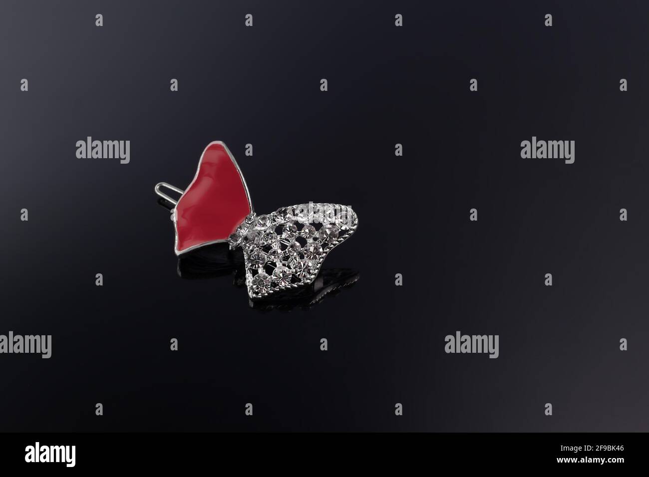 Bijouterie and jewelry on a dark background. Brooches and hairpins ...