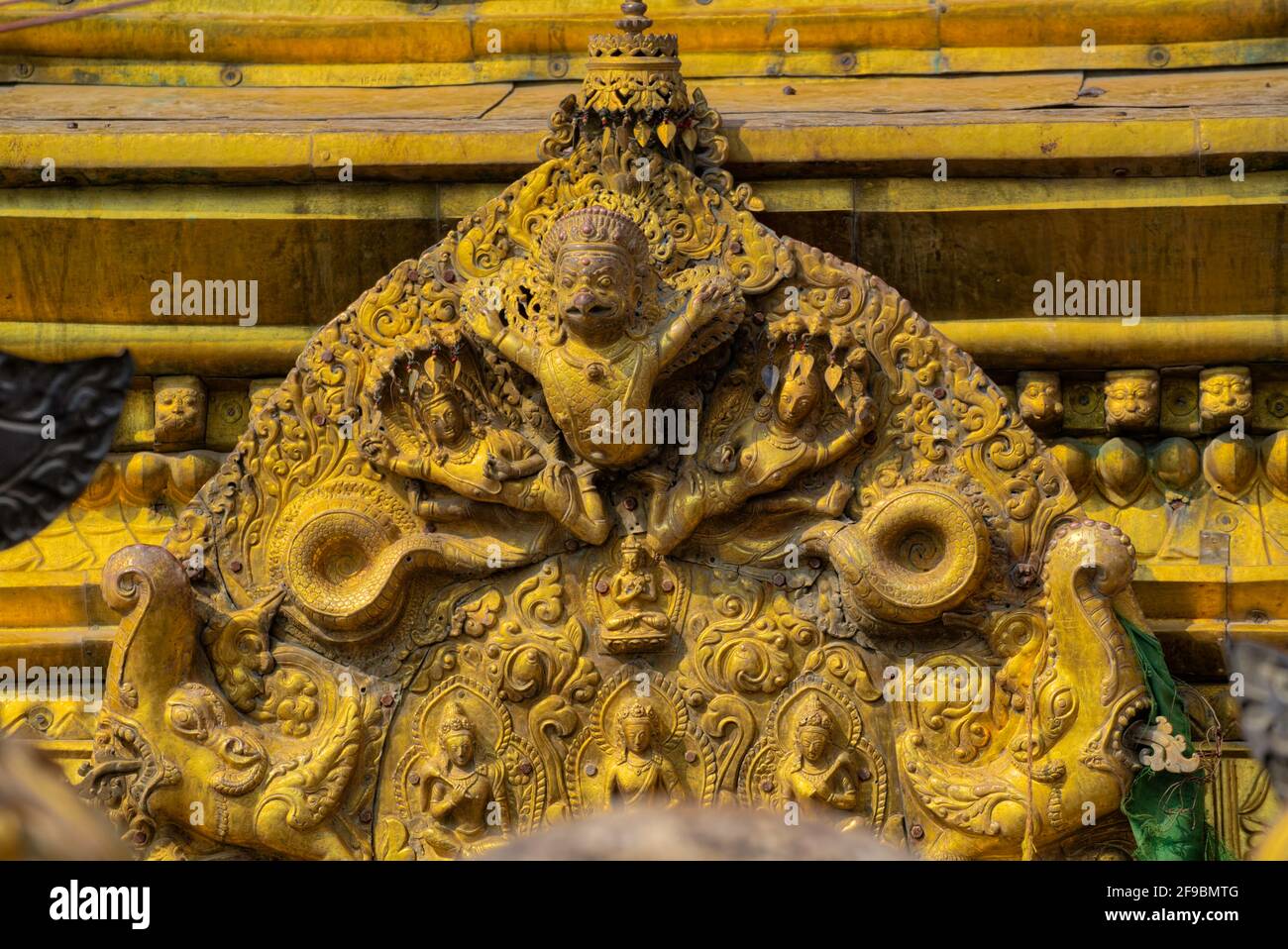 A powerful winged Garuda with a naga (serpent) flowing downwards Taken ...