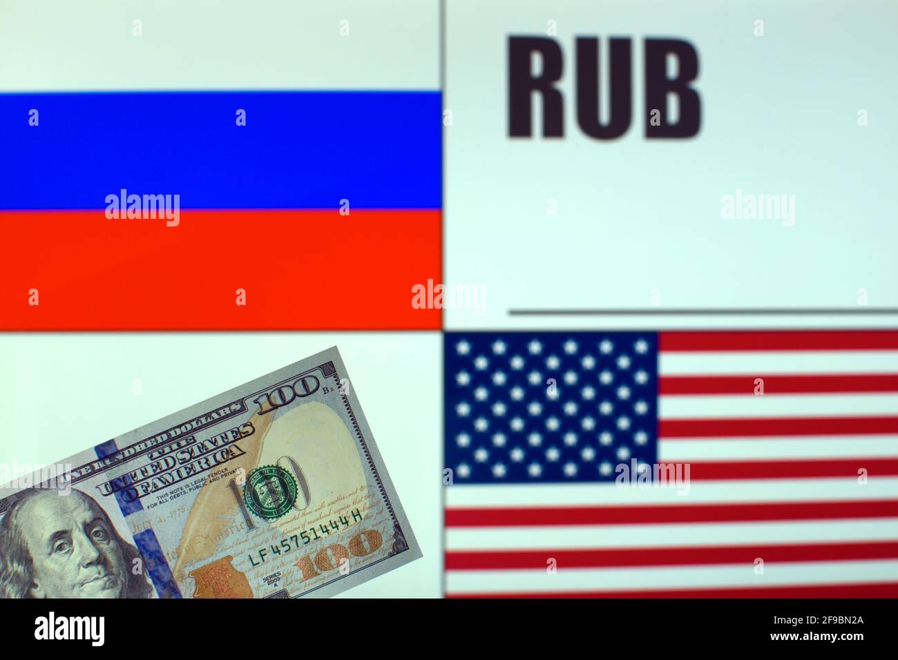 100 US dollars banknote on blurred background of Russian and American ...