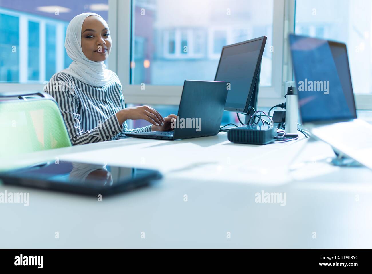 Young muslim African American business woman as a leader at work ...