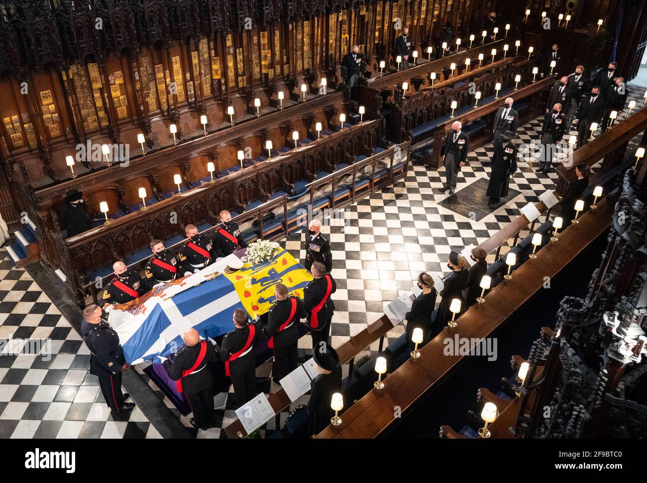 Queen Elizabeth II watches as pallbearers carry the coffin of the Duke ...