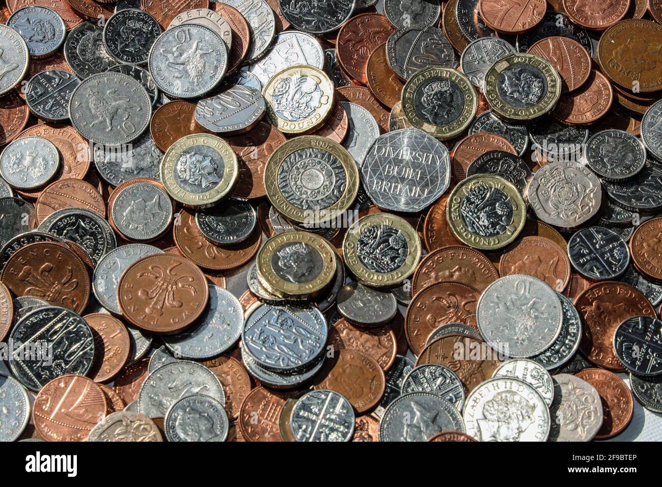 British metric coins on a table with 1p, 2p, 5p, 10p 20p, 50p, £1 and £ ...