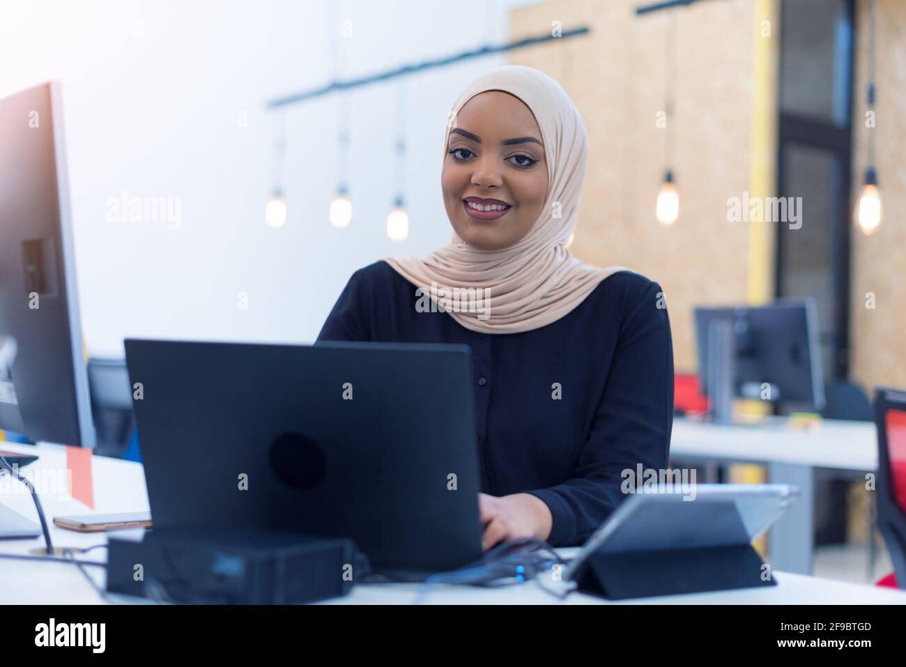 Young muslim African American business woman as a leader at work ...