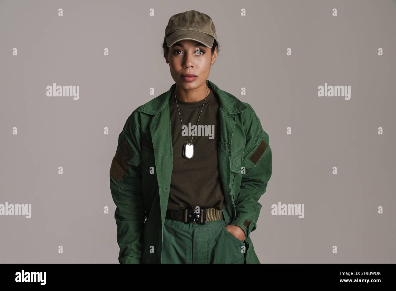 Confident african american soldier woman posing with hand in her pocket ...