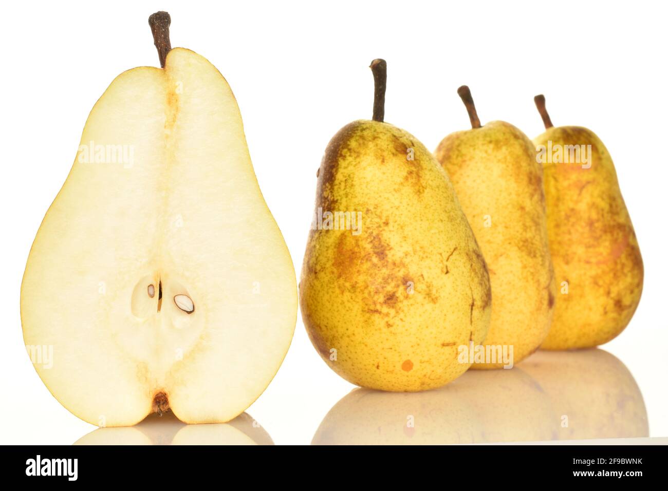 One half ripe sweet pear, in focus, macro. Two whole pears in the ...