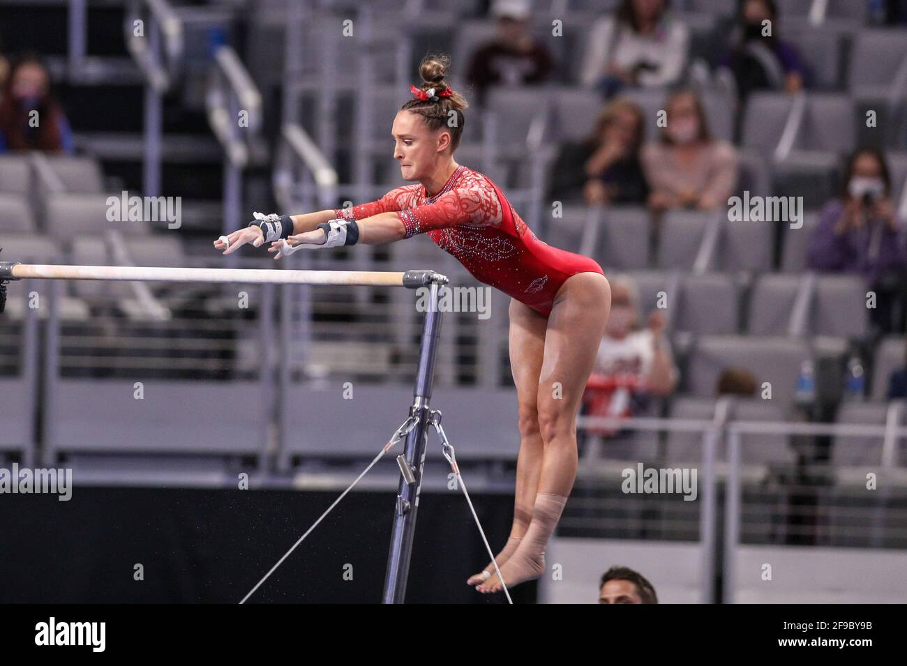 Arkansas' Kennedy Hambrick performs a release move on the uneven ...