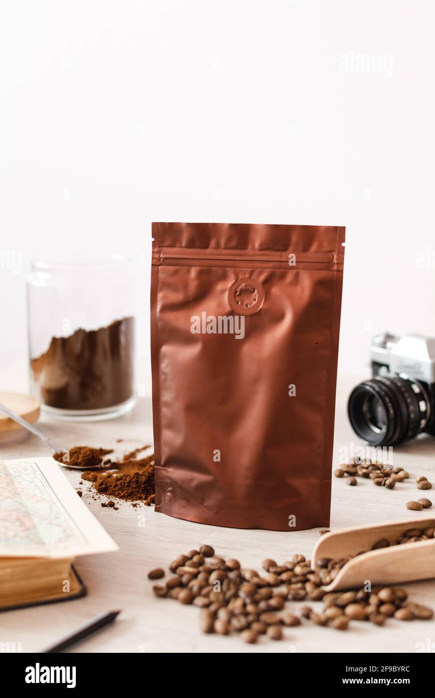 Blank coffee packaging on a wooden table, with coffee seeds, wooden ...