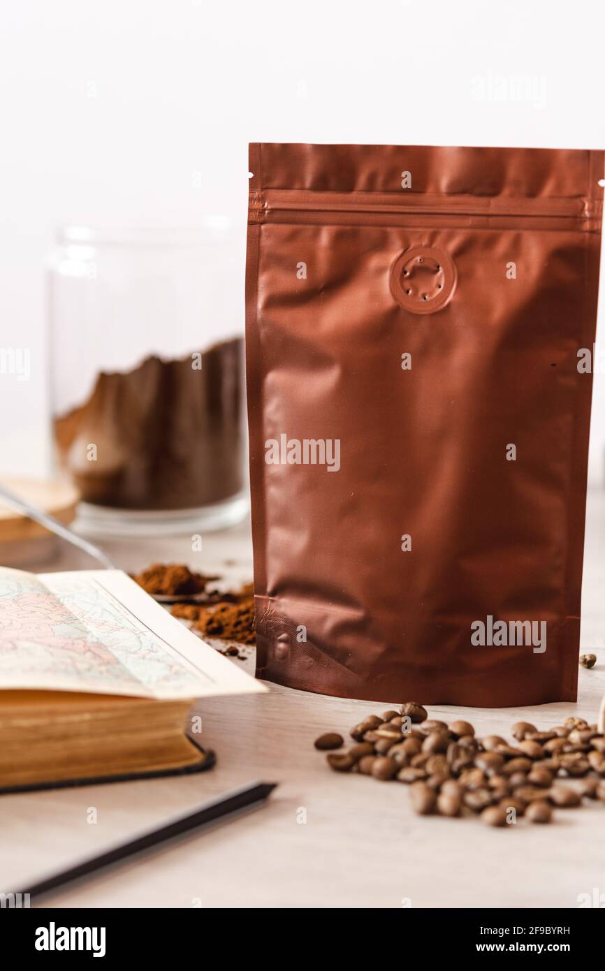 Blank coffee packaging with coffee seeds, book and glass jar with ...