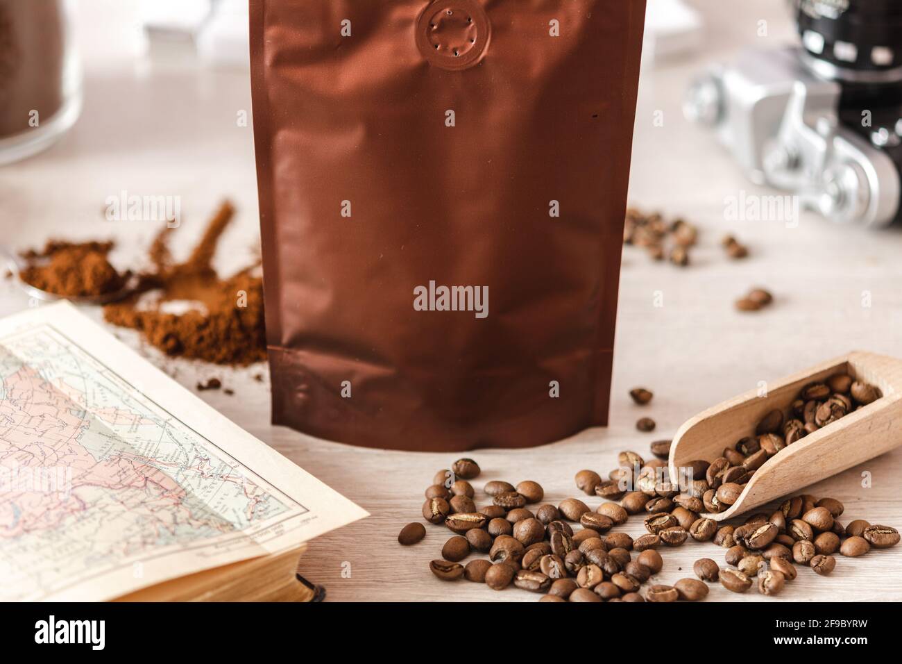 Blank coffee packaging with coffee seeds, book and glass jar with ...