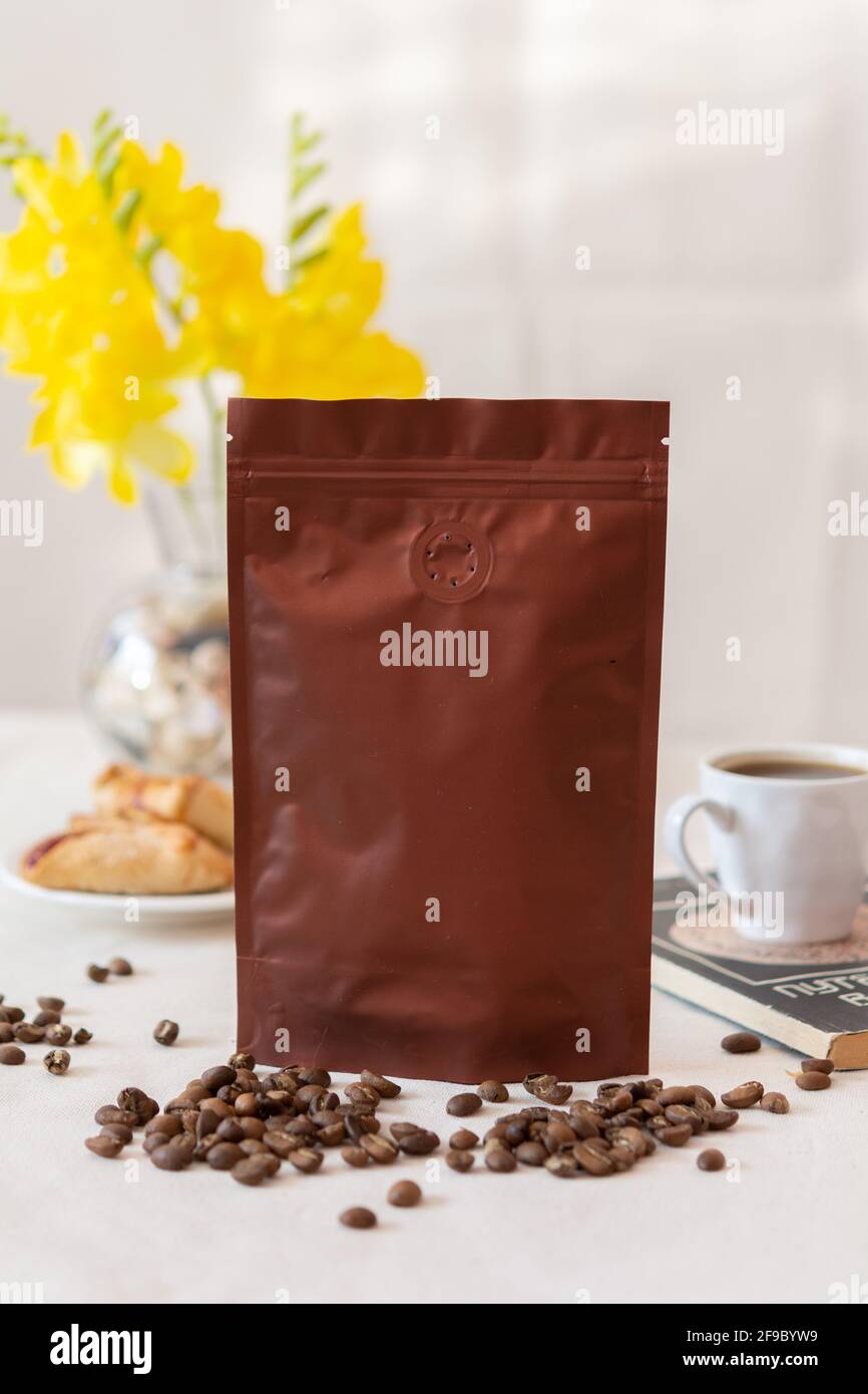 Blank coffee packaging, coffee seeds, cup with coffee on old book ...