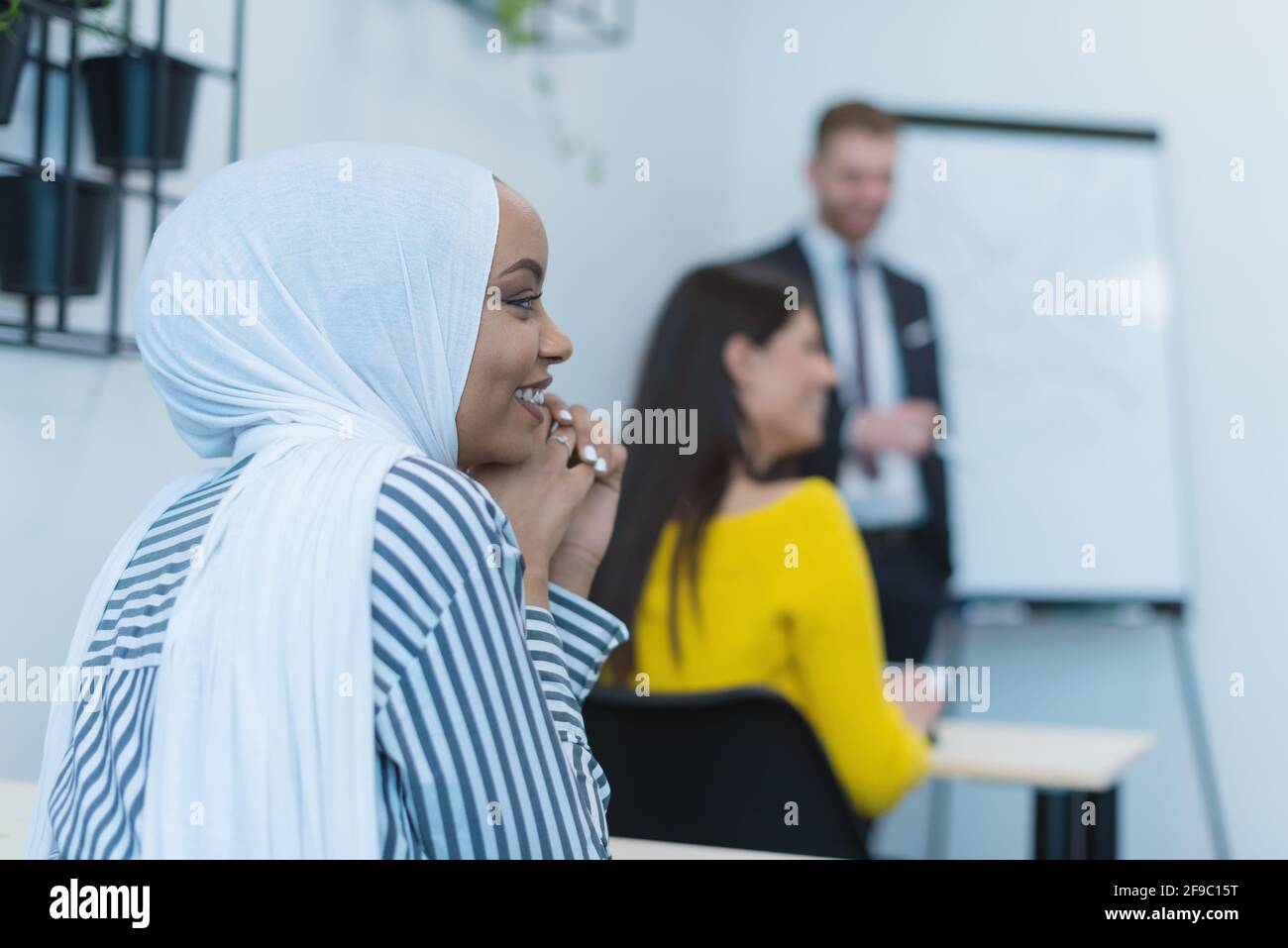 Group of people listening to a presentation speech and working and ...