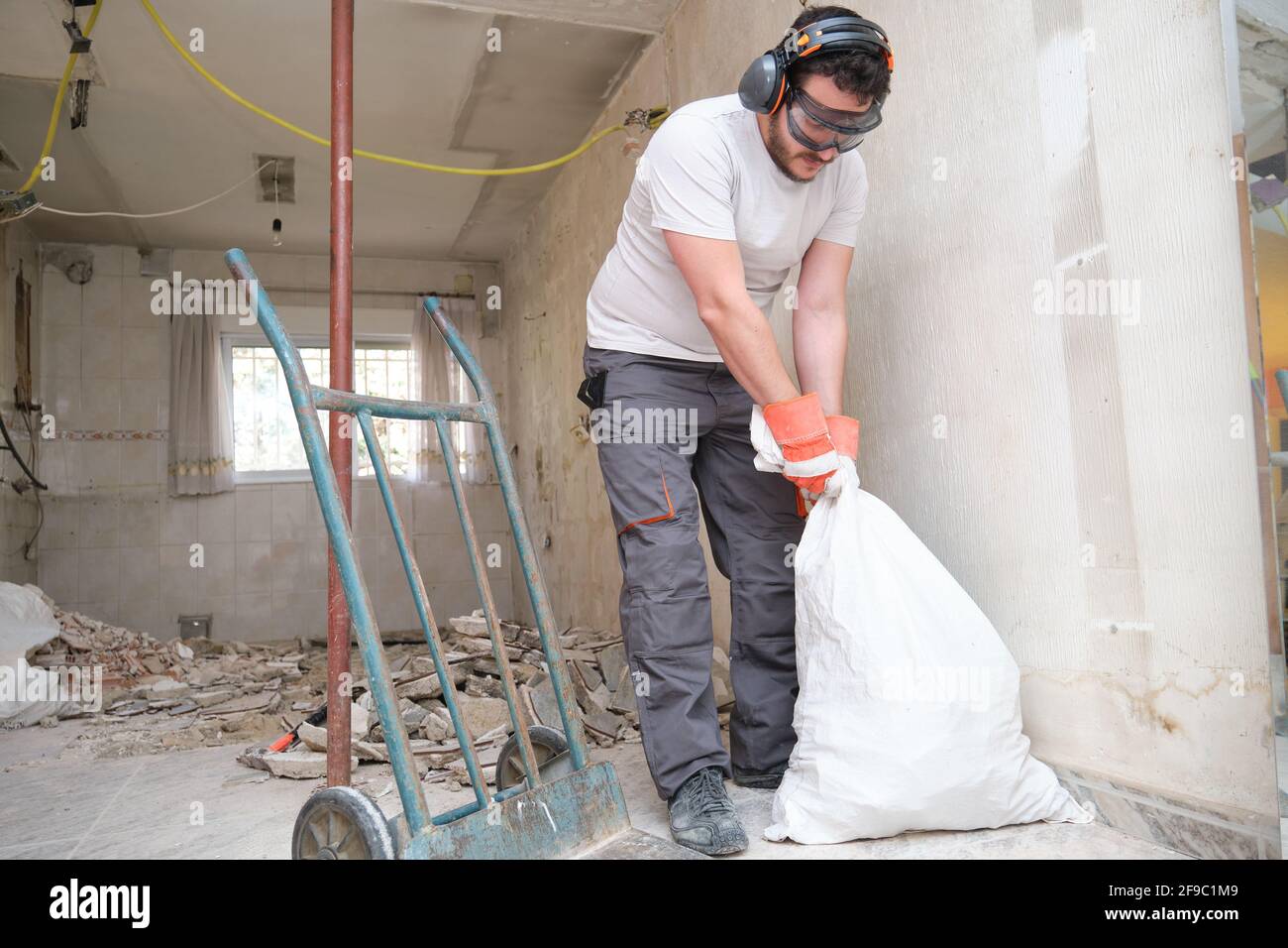 Man is carrying the garbage bag hi-res stock photography and images - Alamy