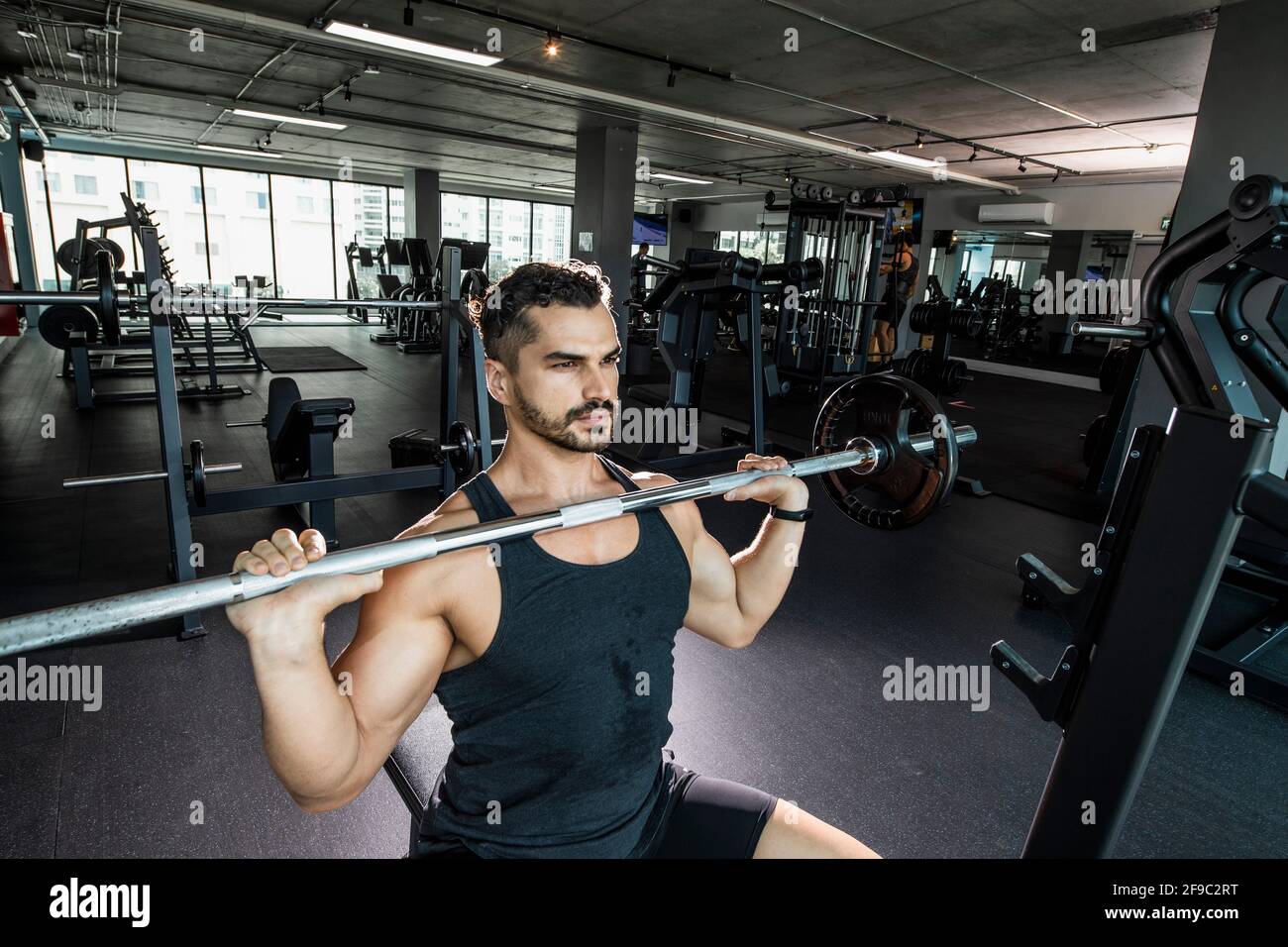 men exercising barbell over head press at gym in Bangkok Stock Photo ...