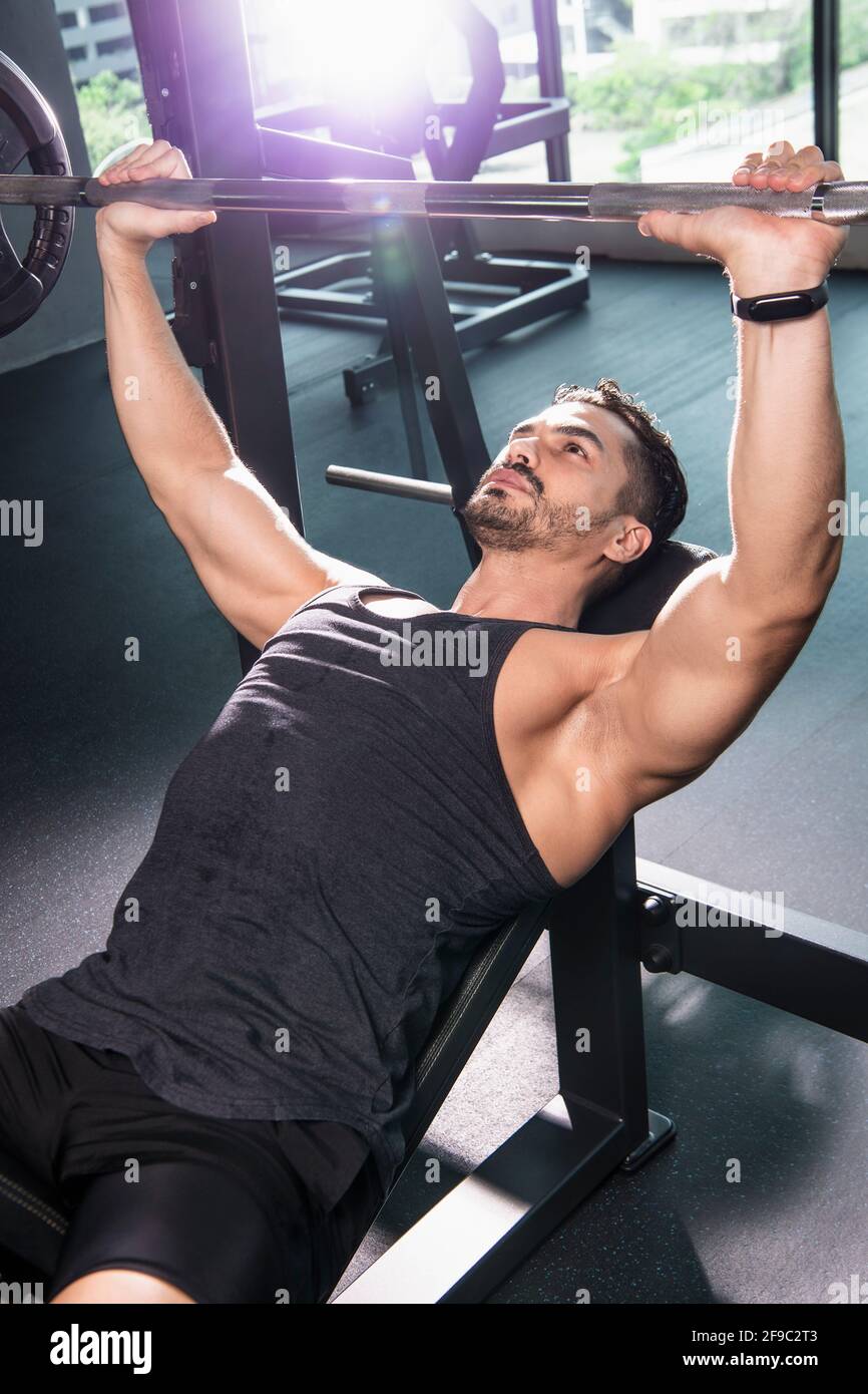 men performing overhead bench presses at gym in Bangkok Stock Photo - Alamy