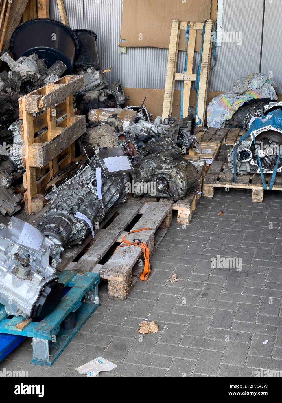 repaired engine gearboxes lie on wooden pallets in a shed Stock Photo ...