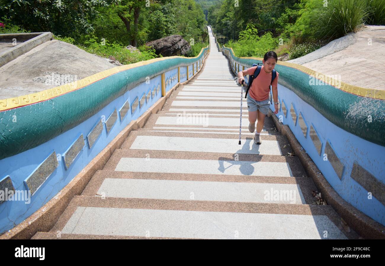 A girl walking up the very long stairs Stock Photo - Alamy