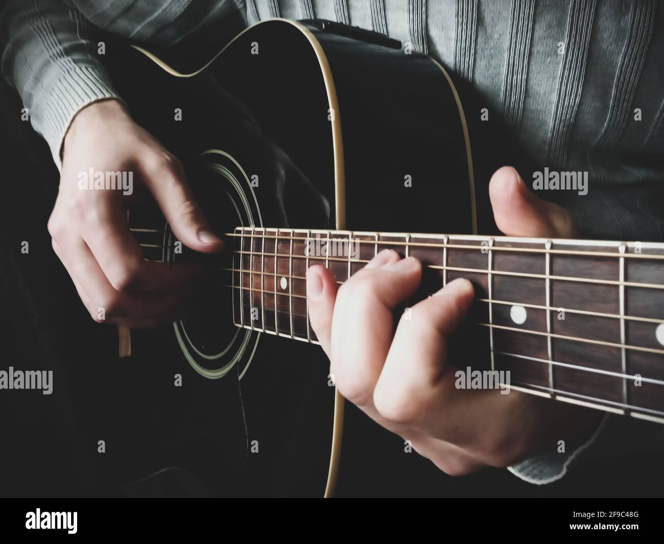 man's hands playing acoustic guitar closeup Stock Photo - Alamy