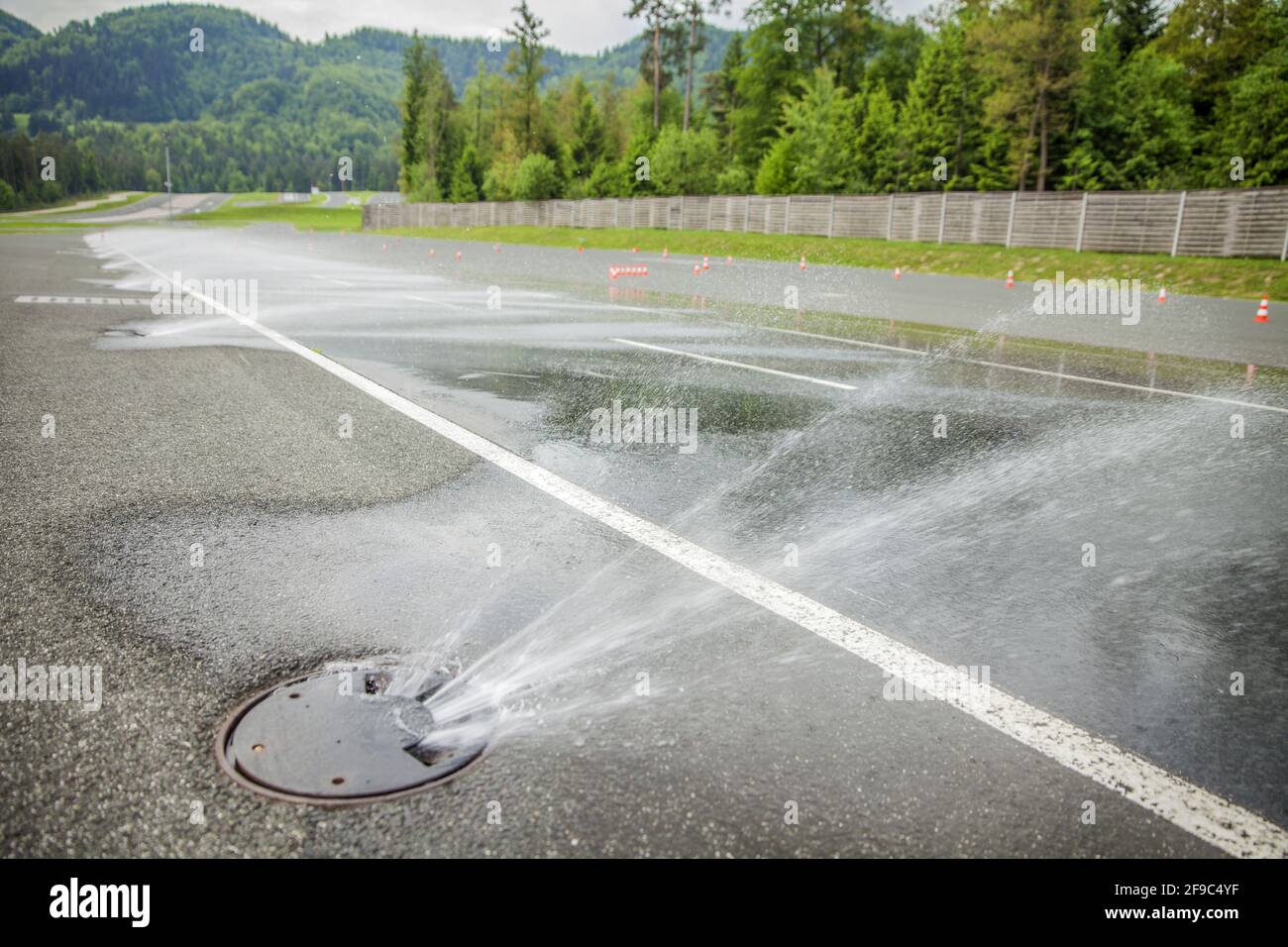 Water road sprinkler hi-res stock photography and images - Alamy