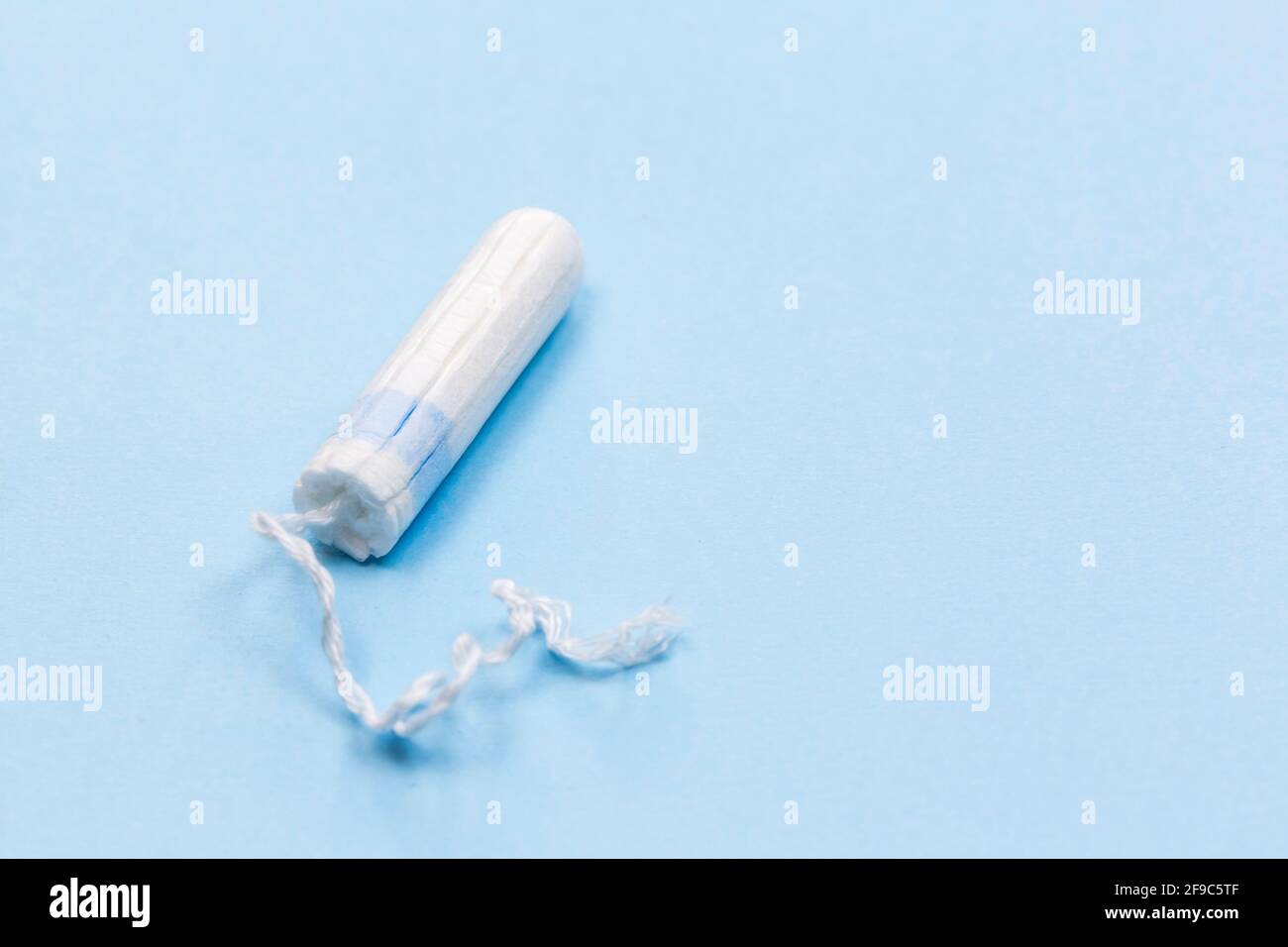 White tampon on the blue background, medical banner Stock Photo - Alamy