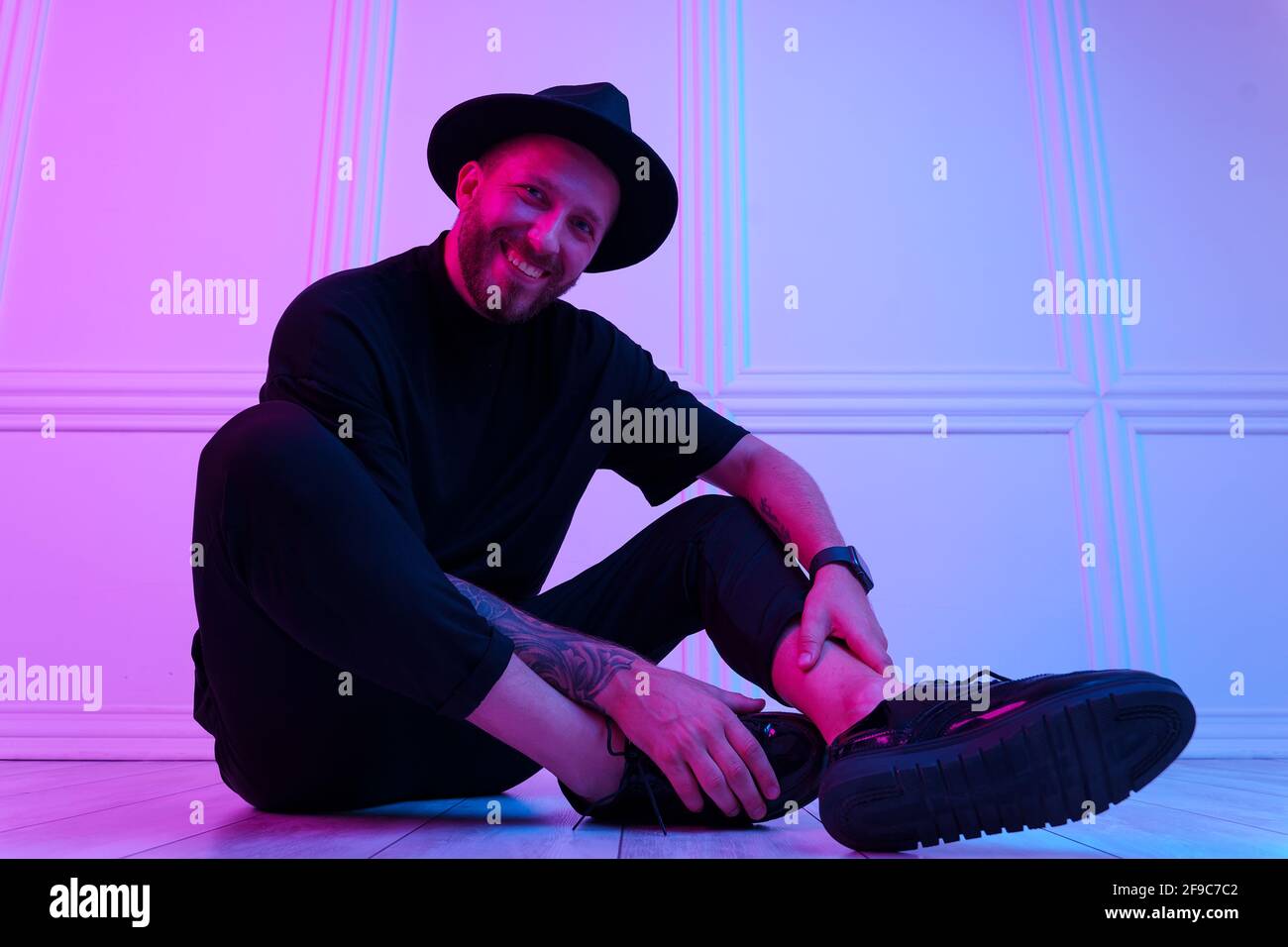 Fashionable guy. Studio shot in dark studio with neon light. Por Stock ...