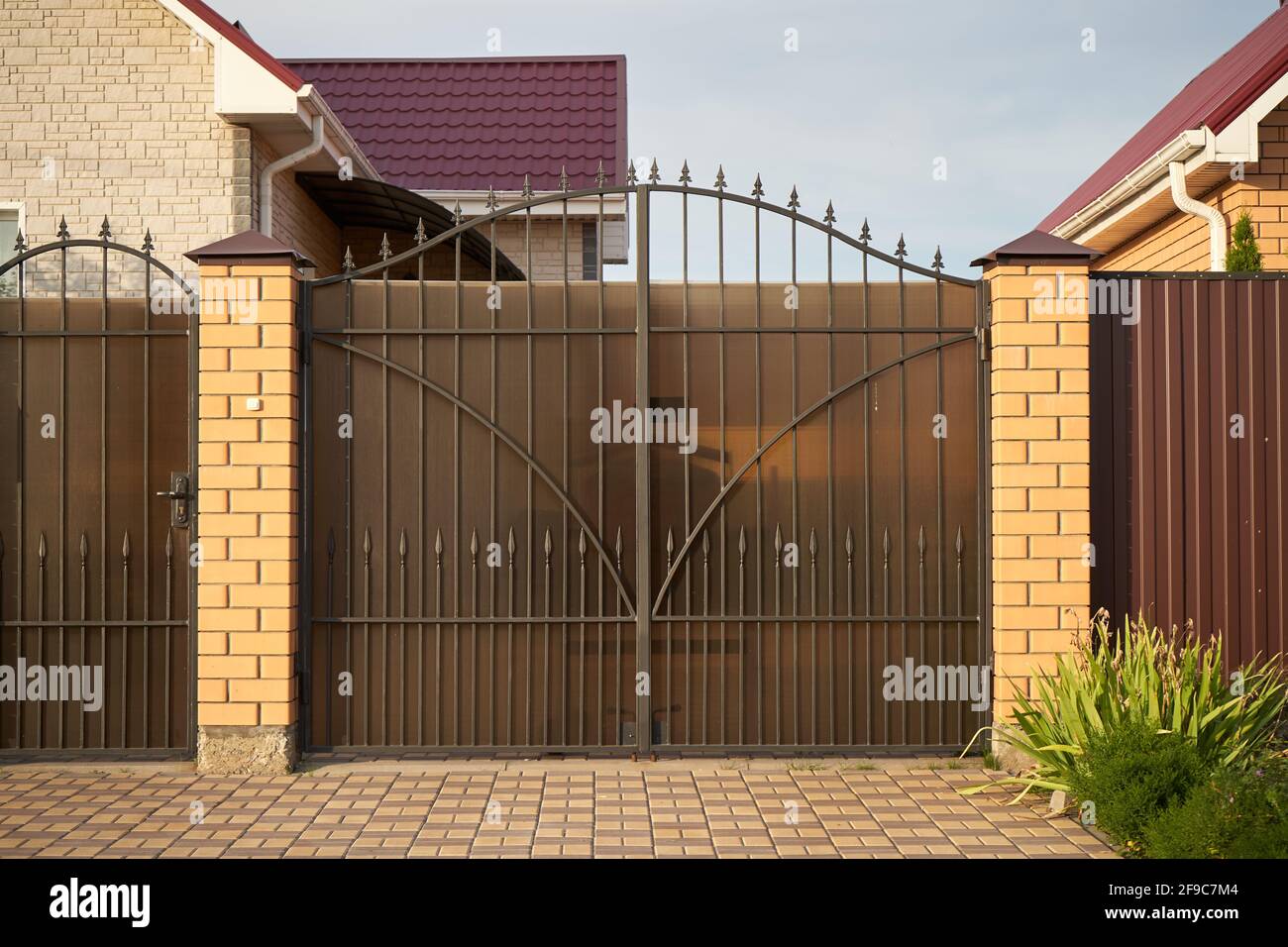 Metal forged gate for entering a private house Stock Photo - Alamy