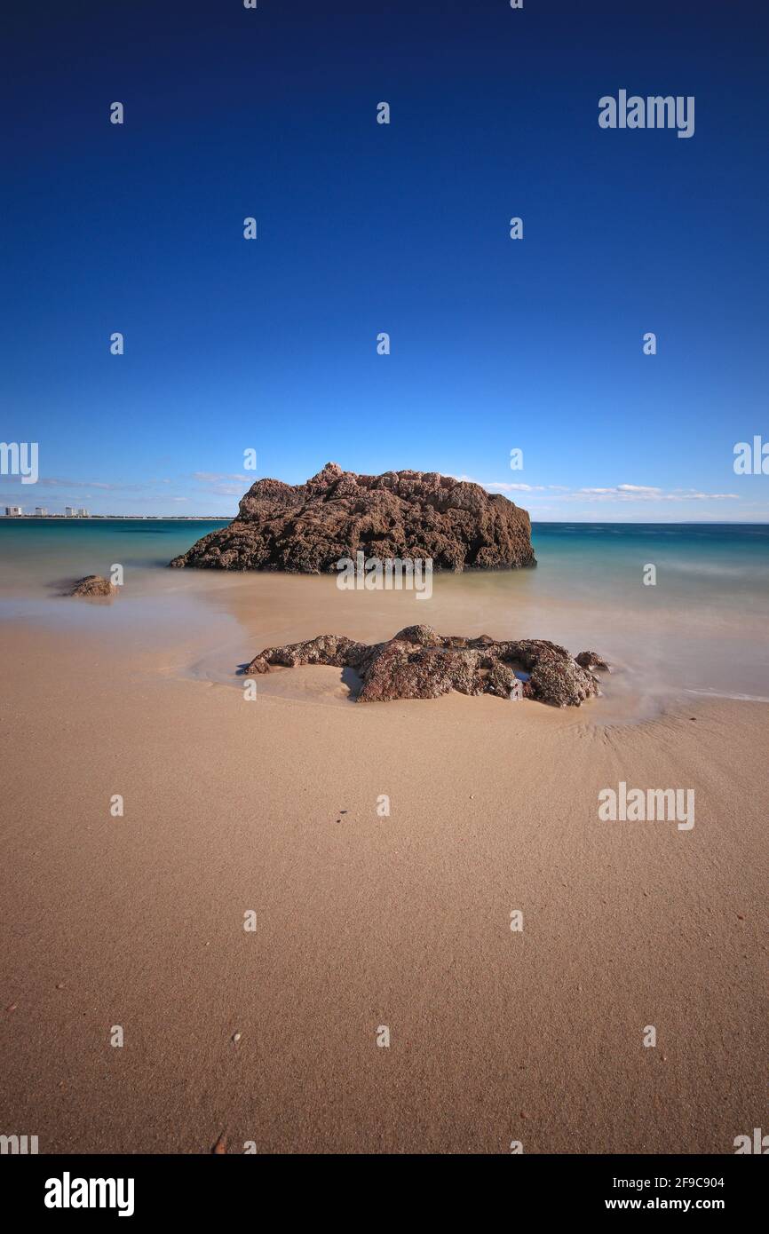 Beach with turquoise sea water with rocks. long exposure Stock Photo ...