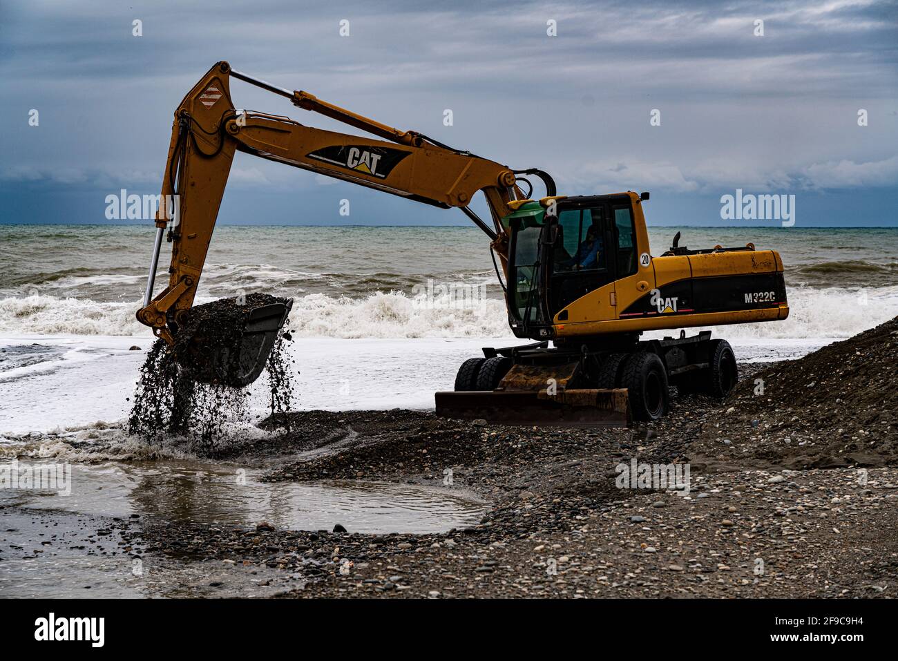 Excavator digging sand on beach hi-res stock photography and images - Alamy