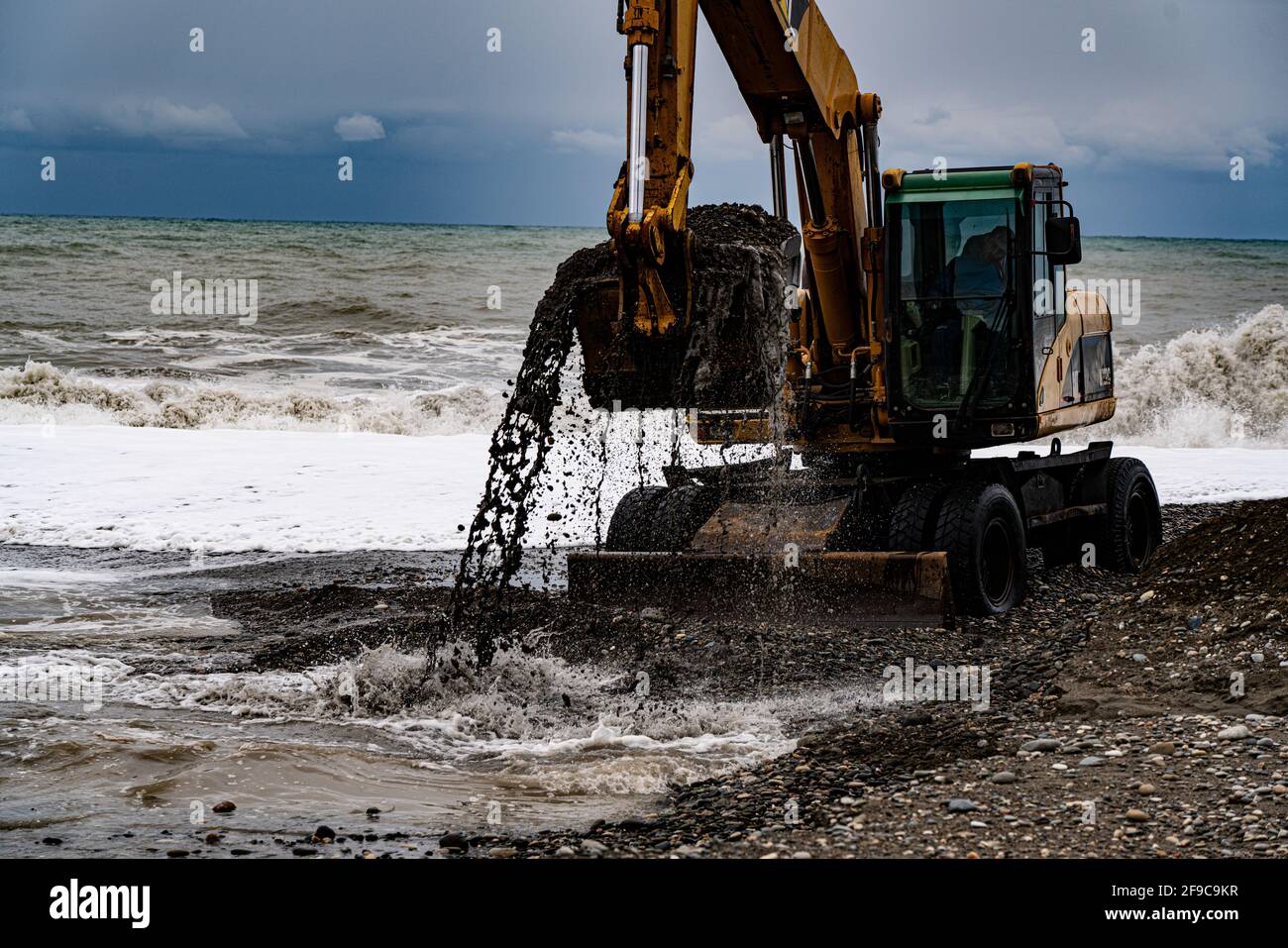 Excavator digging sand on beach hi-res stock photography and images - Alamy