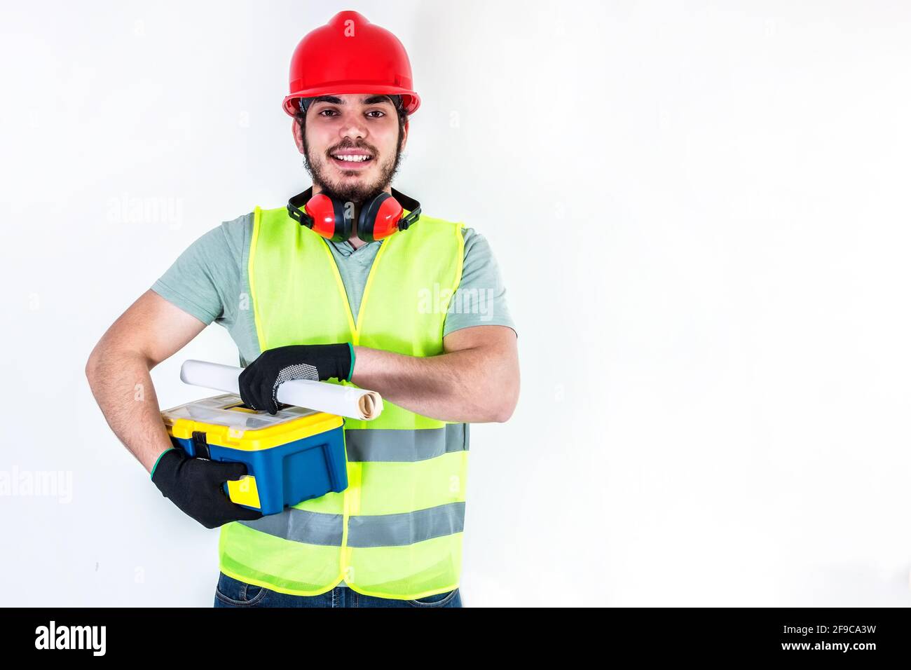 Young Israeli male construction worker with a tool bag and helmet in ...