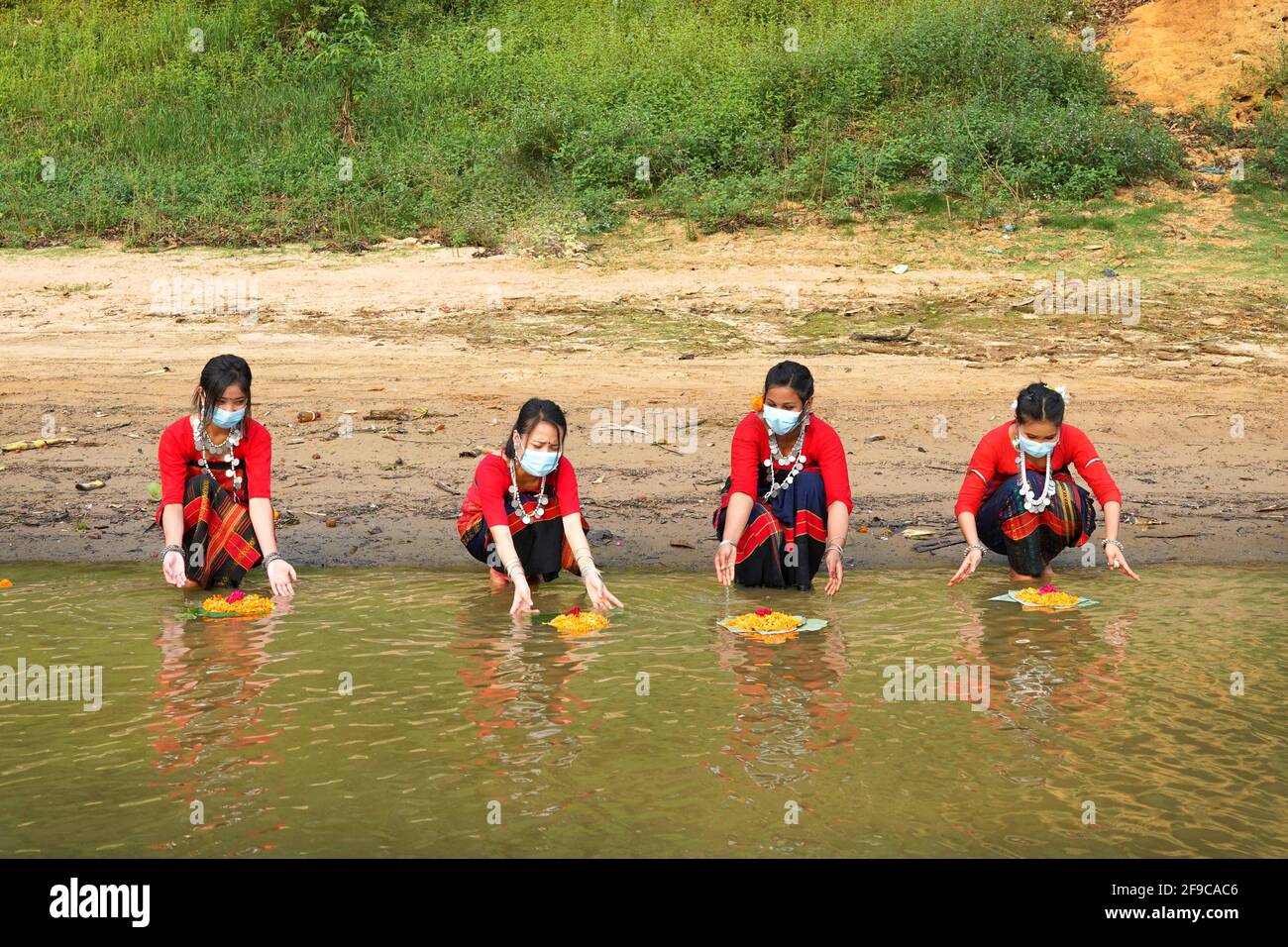 Rangamati, Bangladesh. 12th Apr, 2021. Women seen pushing their flowers ...