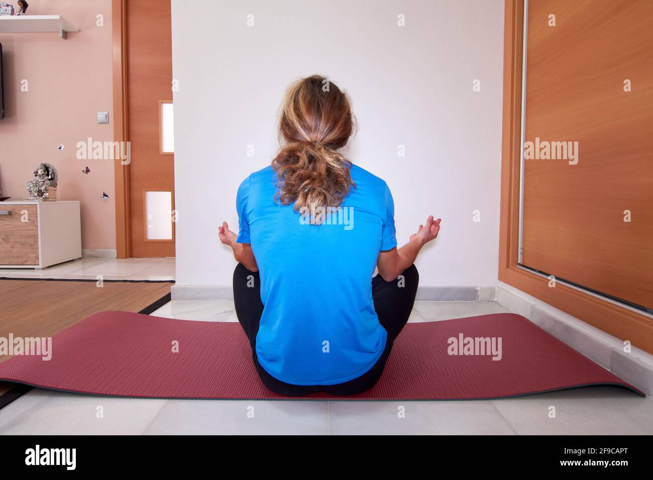 Back view of a man sitting on a lotus pose and meditating Stock Photo ...