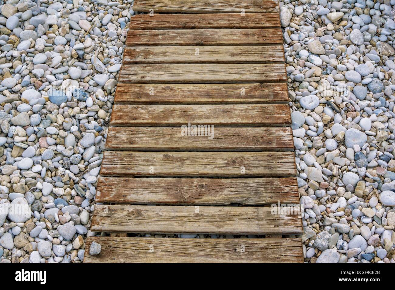 Wooden walkway to sea on pebbles. Path on the beach Stock Photo - Alamy