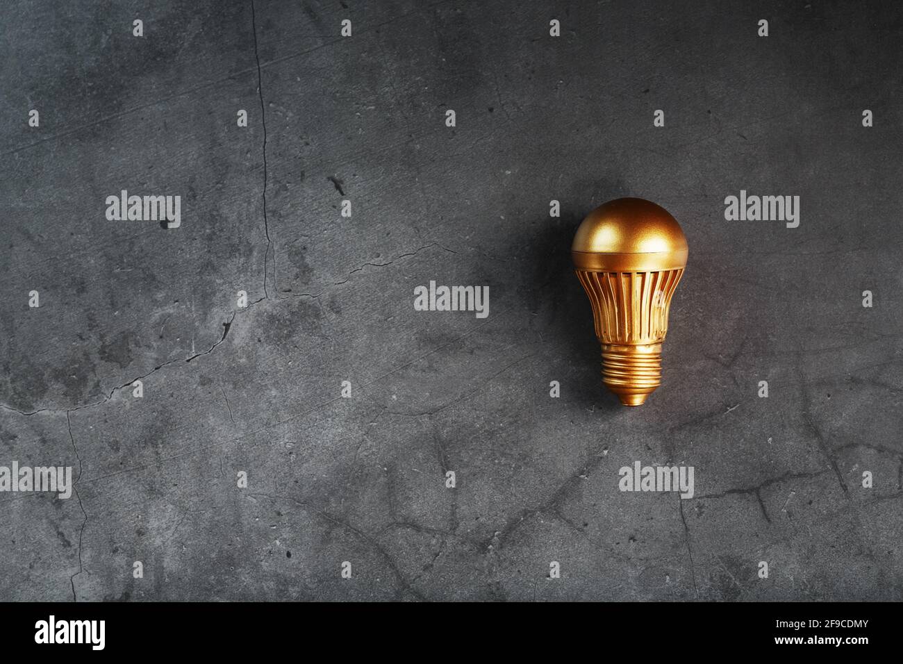 Light bulb from gold on black stone concept of a profitable idea. Top ...