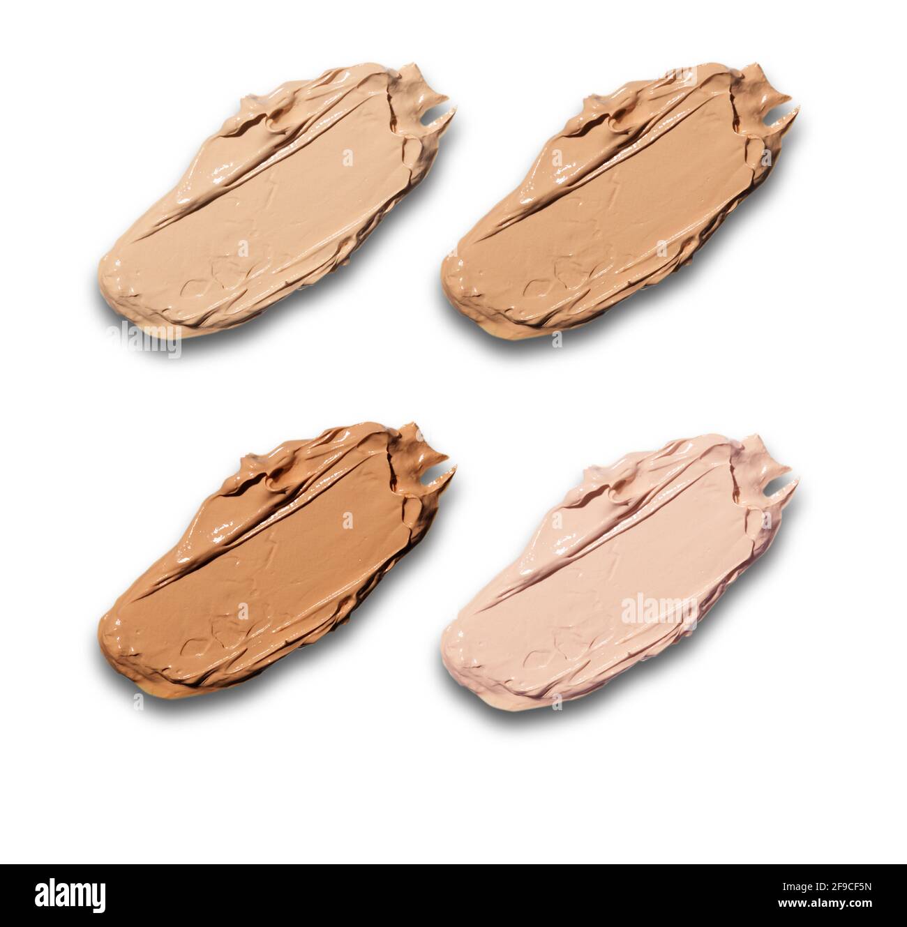 A set of foundation swatches in different shades isolated on a white ...