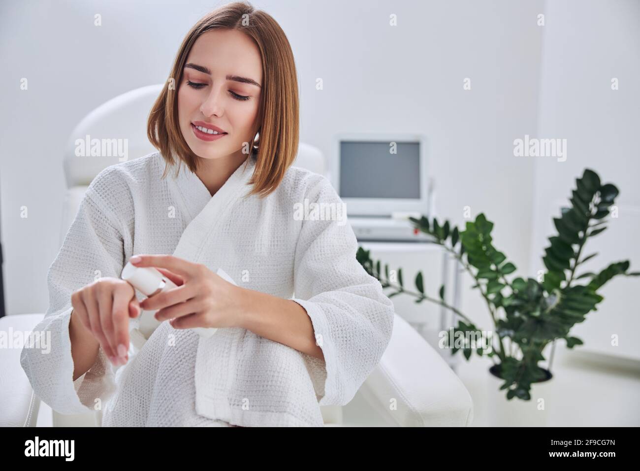 Young beautiful elegant female in white bathrobe spending time in spa relax complex Stock Photo ...