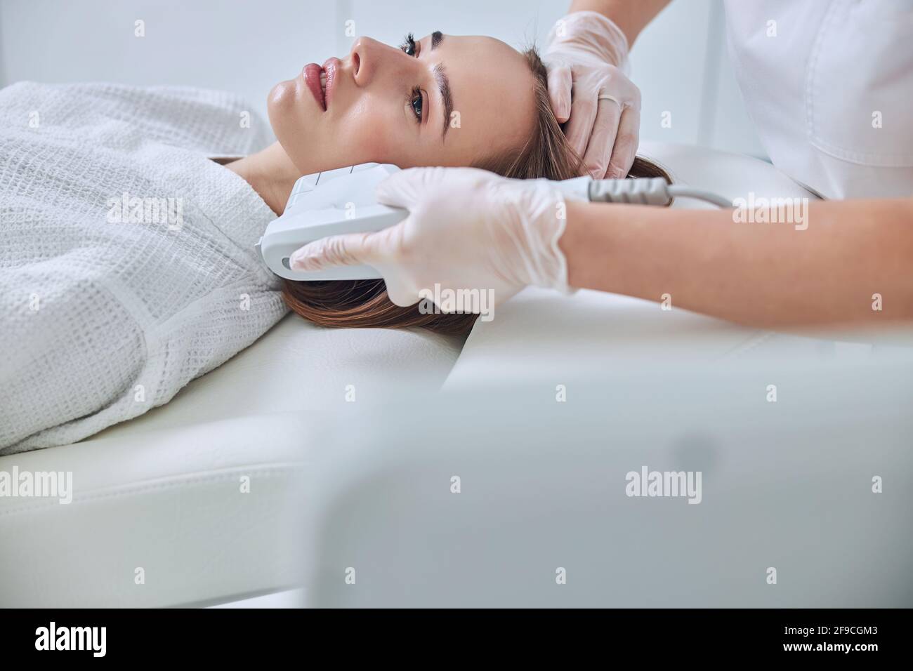Gorgeous charming female getting face lifting in spa salon Stock Photo ...