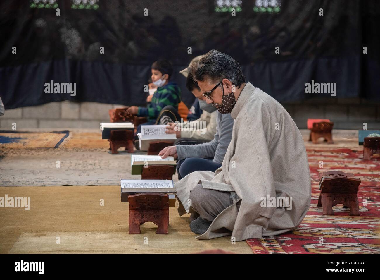 Kashmiri Muslims recite the Islamic Holy book Qur'an during the ...