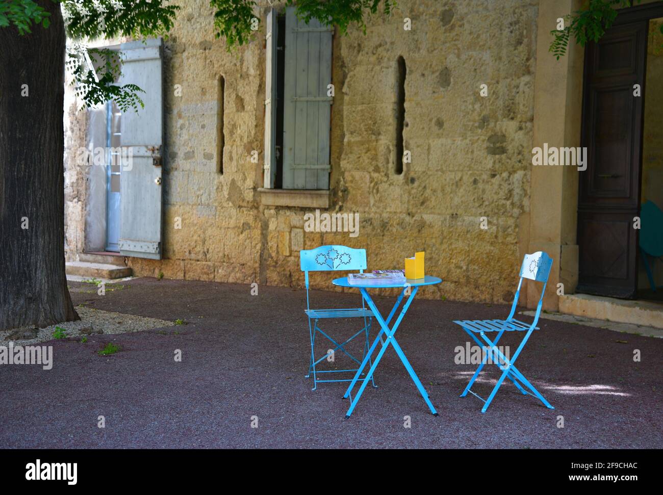 Old Provençal house patio with bright blue fer forge furniture in the ...