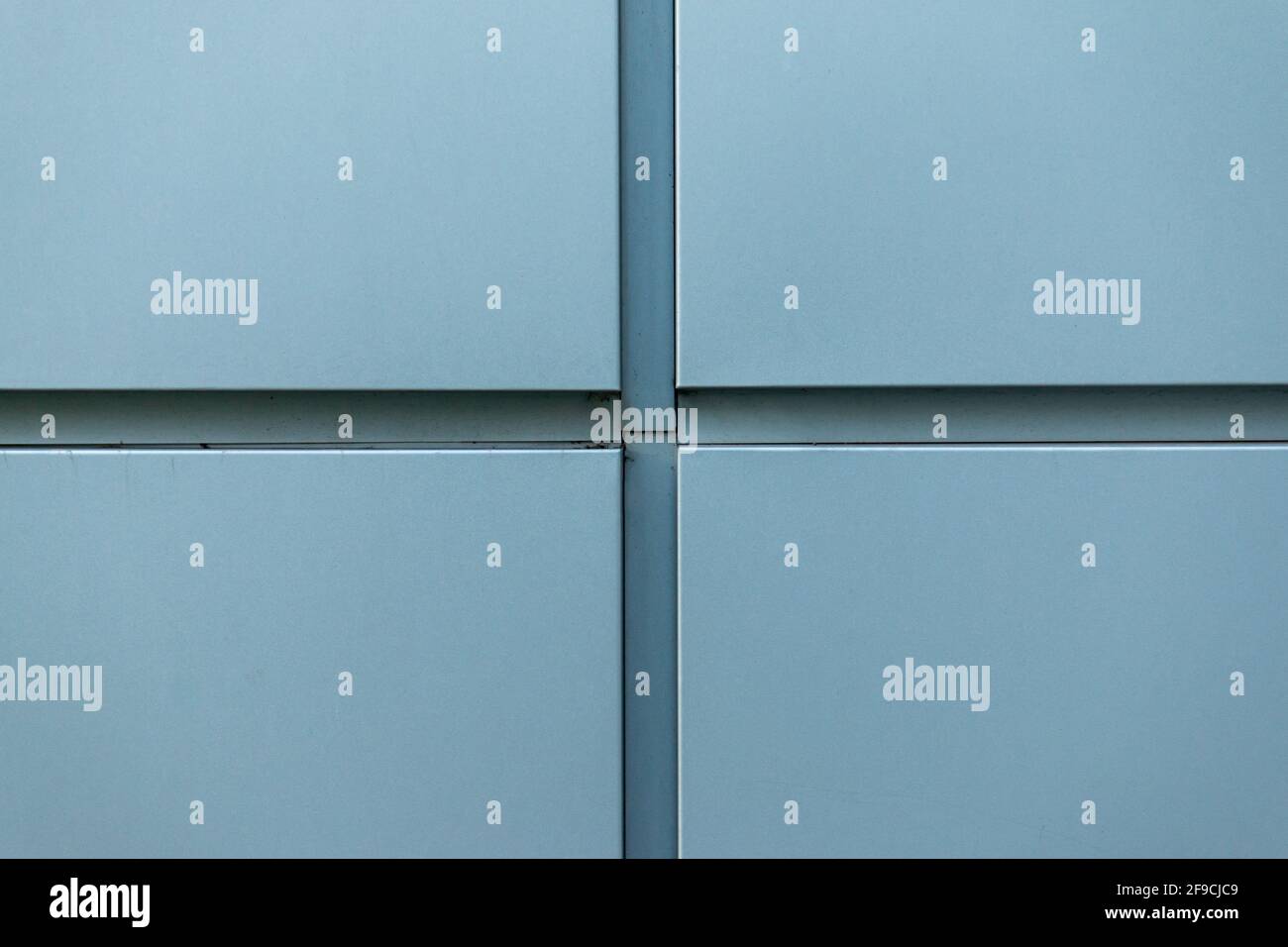 Cross-shaped metal cladding panels on the building wall Stock Photo - Alamy
