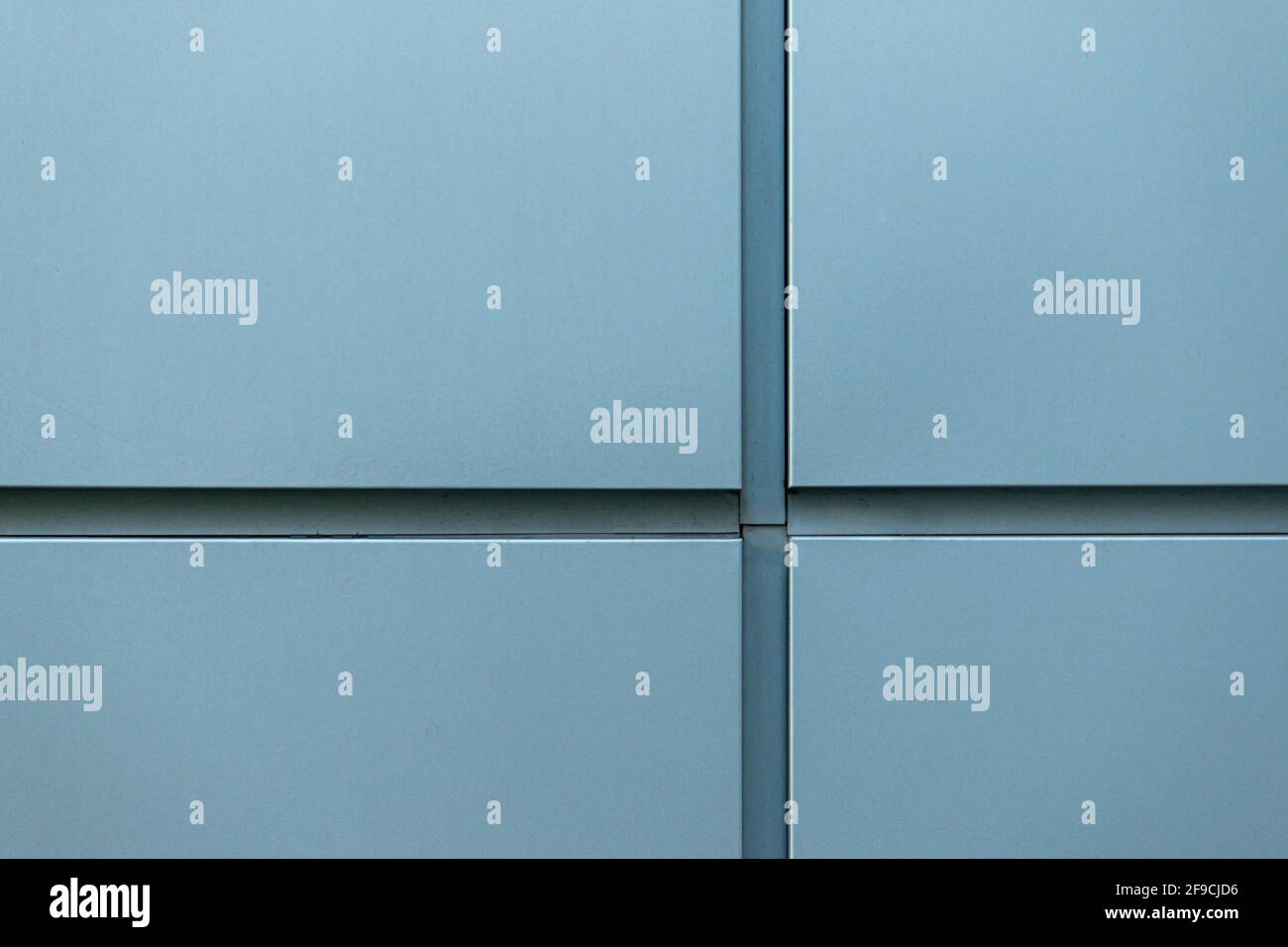 Cross-shaped metal cladding panels on the building wall Stock Photo - Alamy